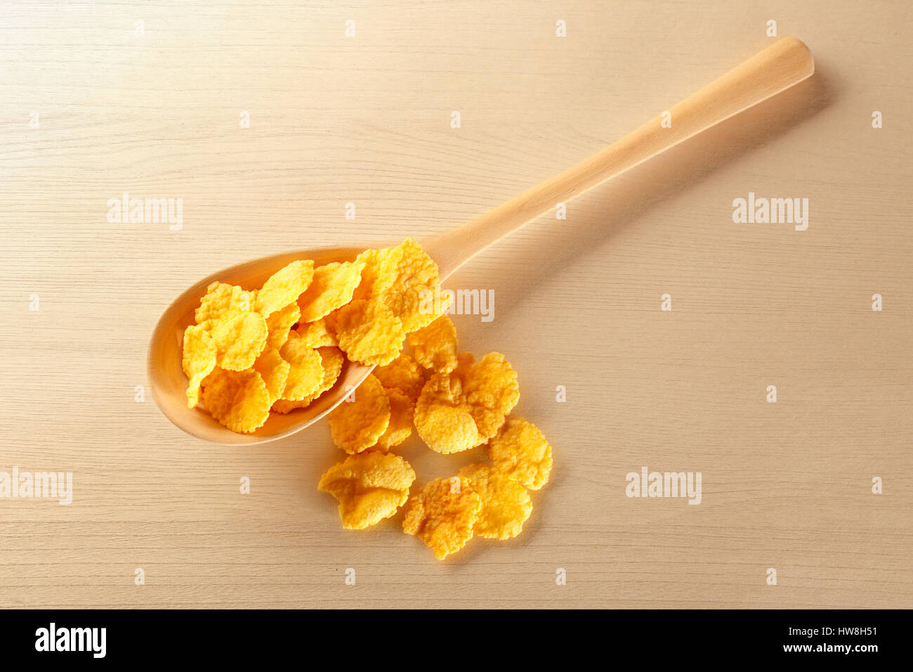 Wooden spoon with corn flakes on paper Stock Photo - Alamy