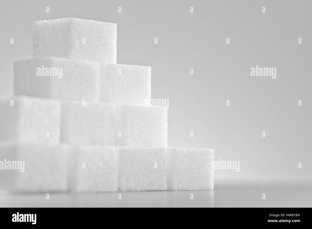 Pile of lump sugar on white background Stock Photo - Alamy