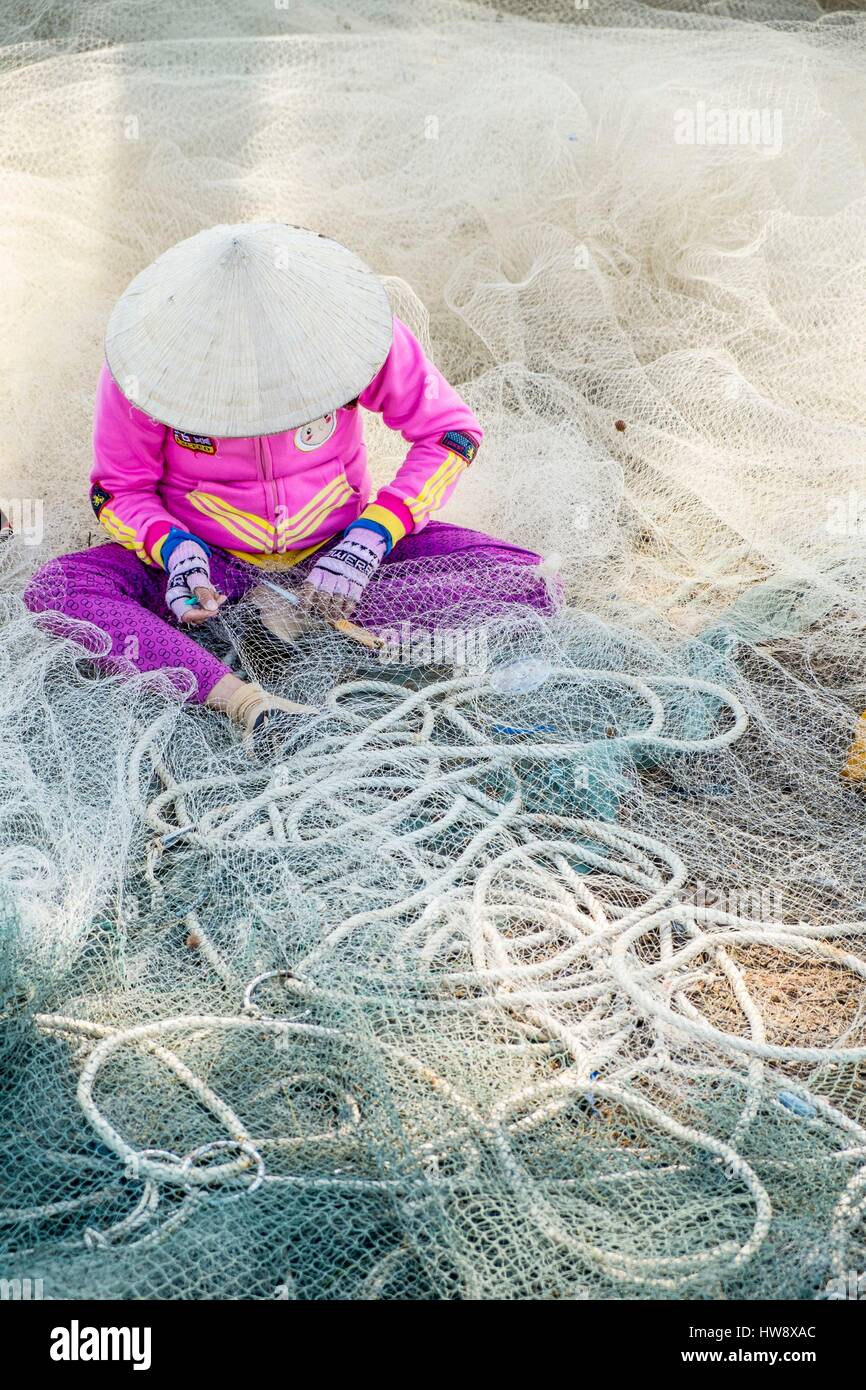 Woman repairing fishing nets hi-res stock photography and images - Alamy