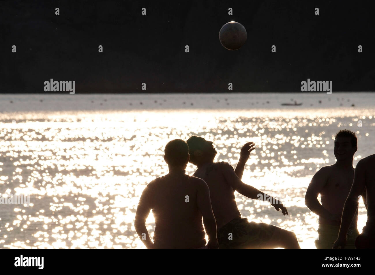 Boy playing football in the sunset hi-res stock photography and images ...