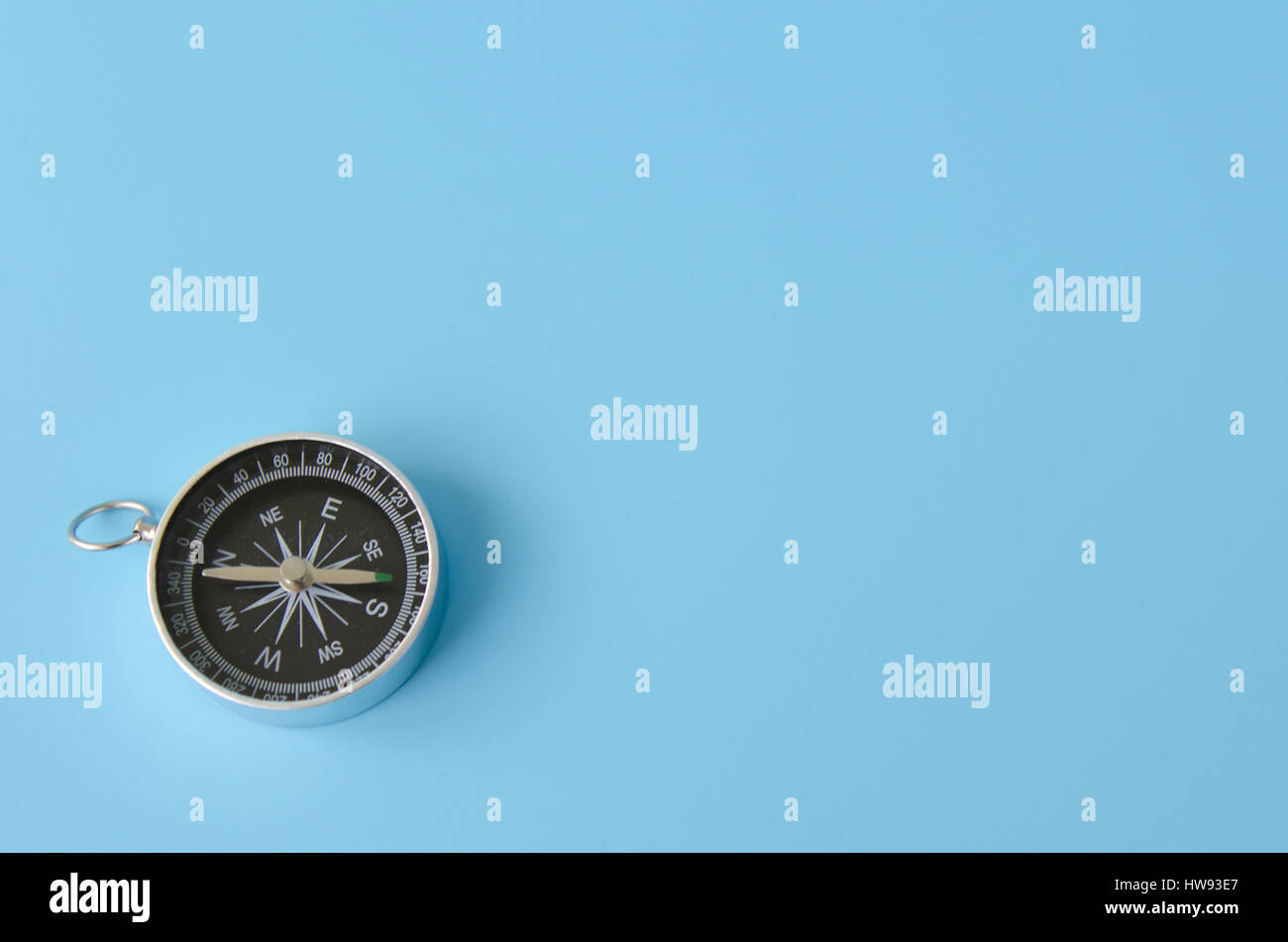 Compass isolated on a blue background Stock Photo - Alamy