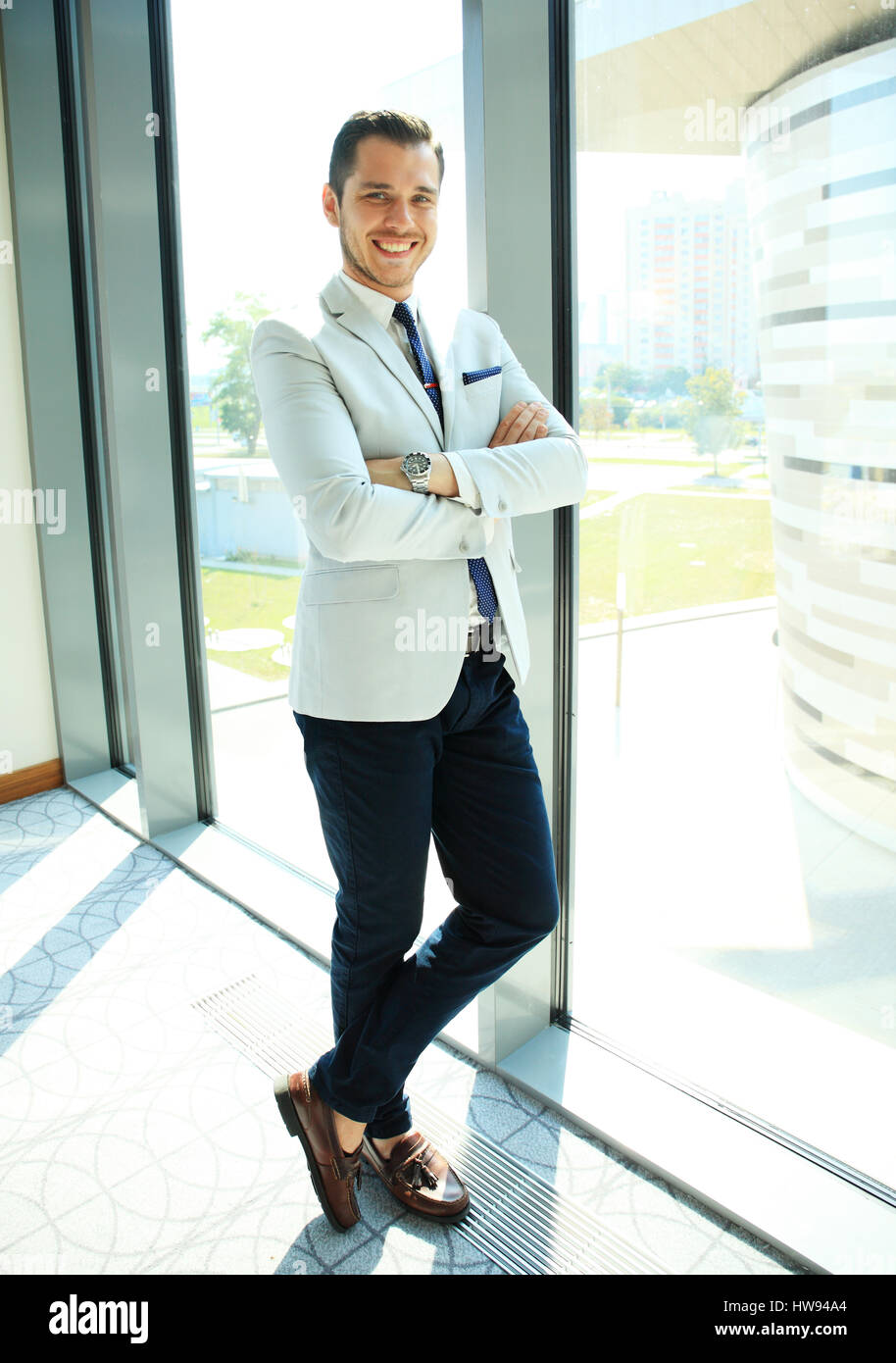 Portrait of a businessman looking at the window Stock Photo - Alamy