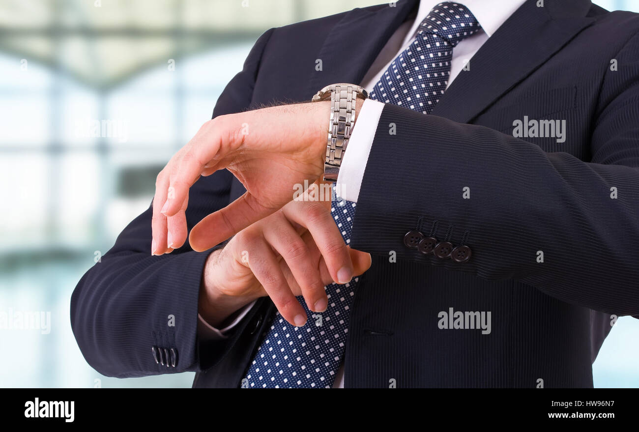 Businessman checking time on his wristwatch Stock Photo - Alamy