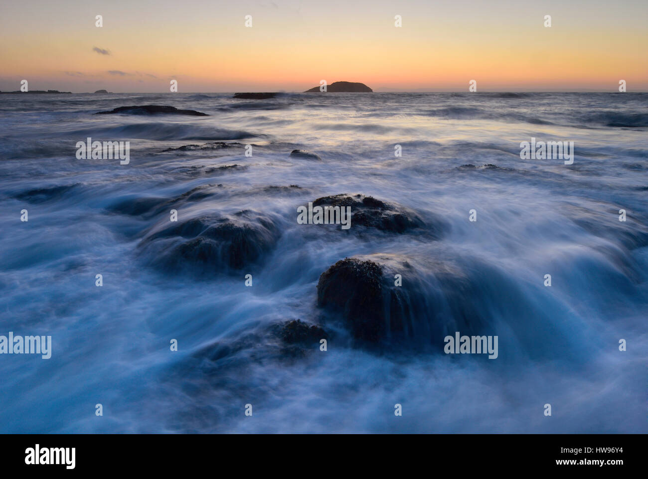 Waves washing around rocks in the ocean, coast in Dunbar, Scotland ...