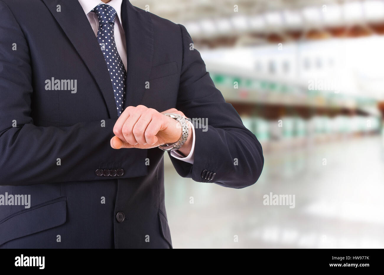 Businessman checking time on his wristwatch Stock Photo - Alamy