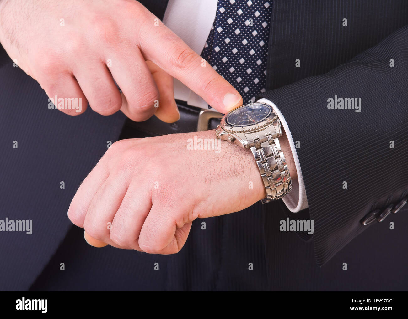 Businessman pointing at his wristwatch Stock Photo - Alamy