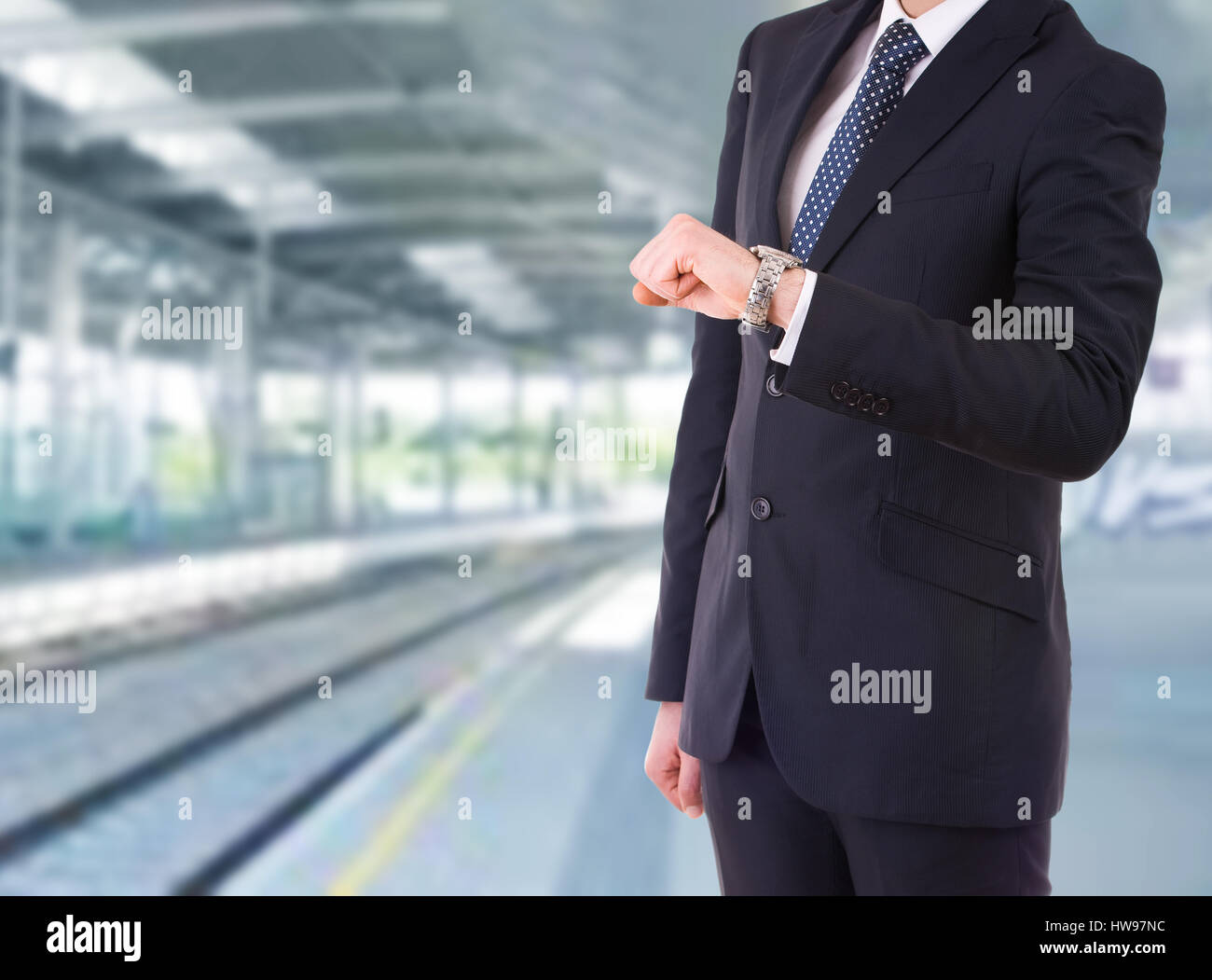 Businessman checking time on his wristwatch Stock Photo - Alamy