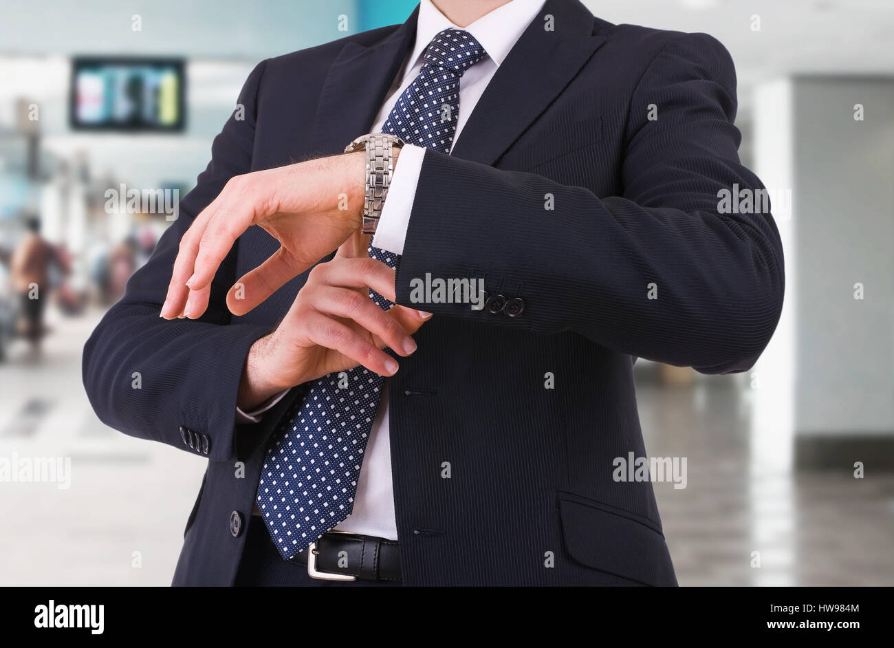 Businessman checking time on his wristwatch Stock Photo - Alamy