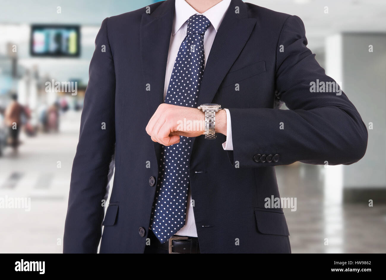 Businessman checking time on his wristwatch Stock Photo - Alamy