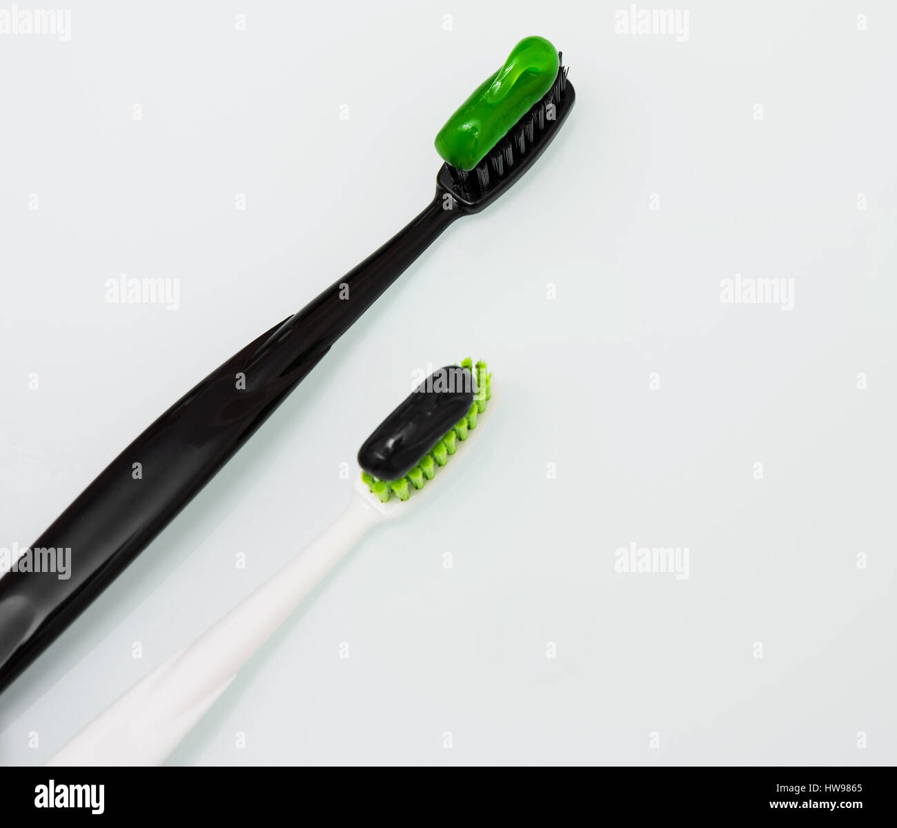black and white toothbrush with toothpaste on a white table Stock Photo ...
