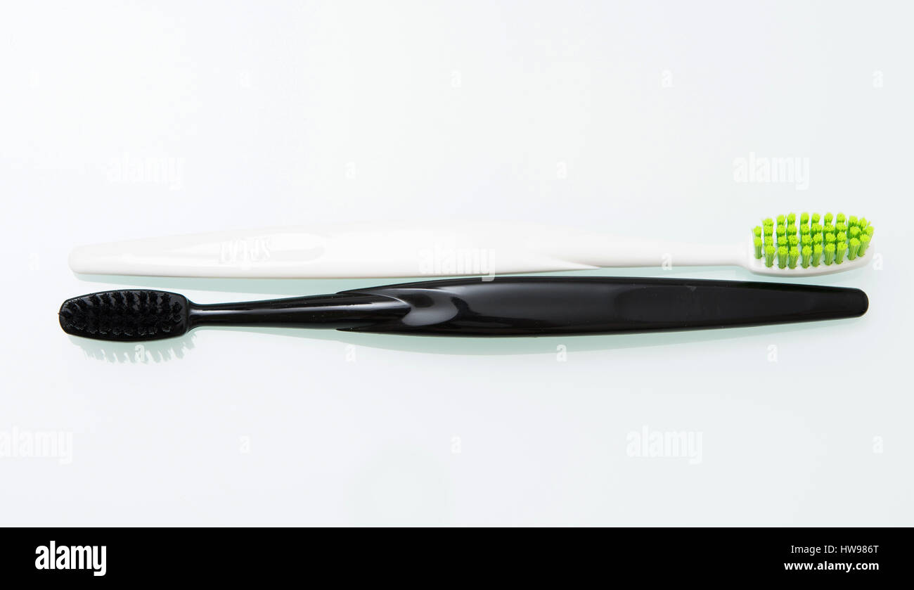 pair of toothbrushes on a white table Stock Photo - Alamy