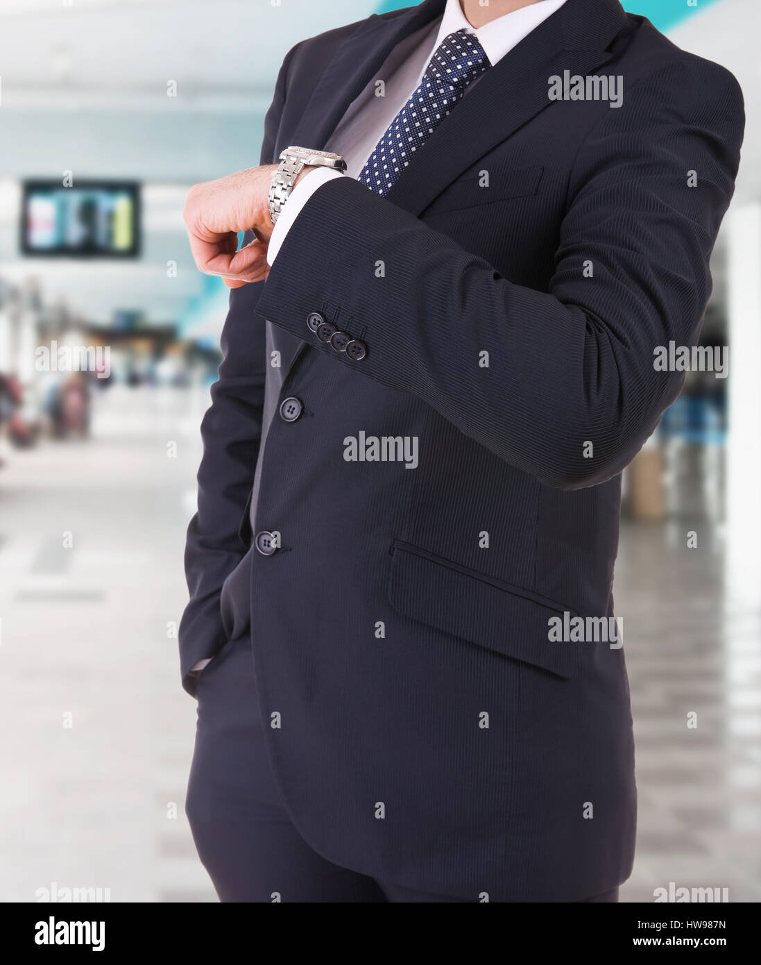 Businessman checking time on his wristwatch Stock Photo - Alamy