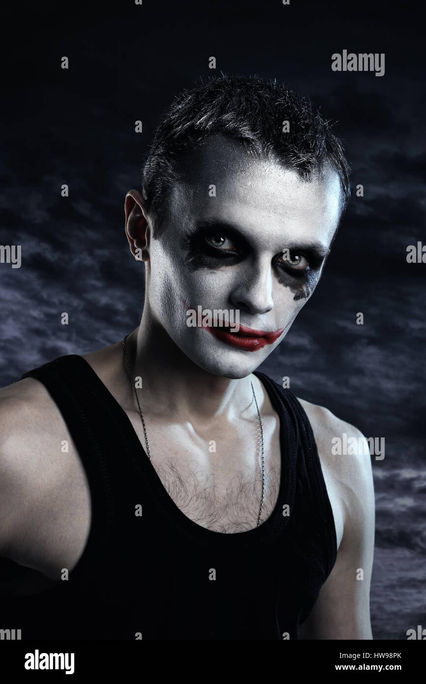 Spooky man joker on dark background Stock Photo - Alamy