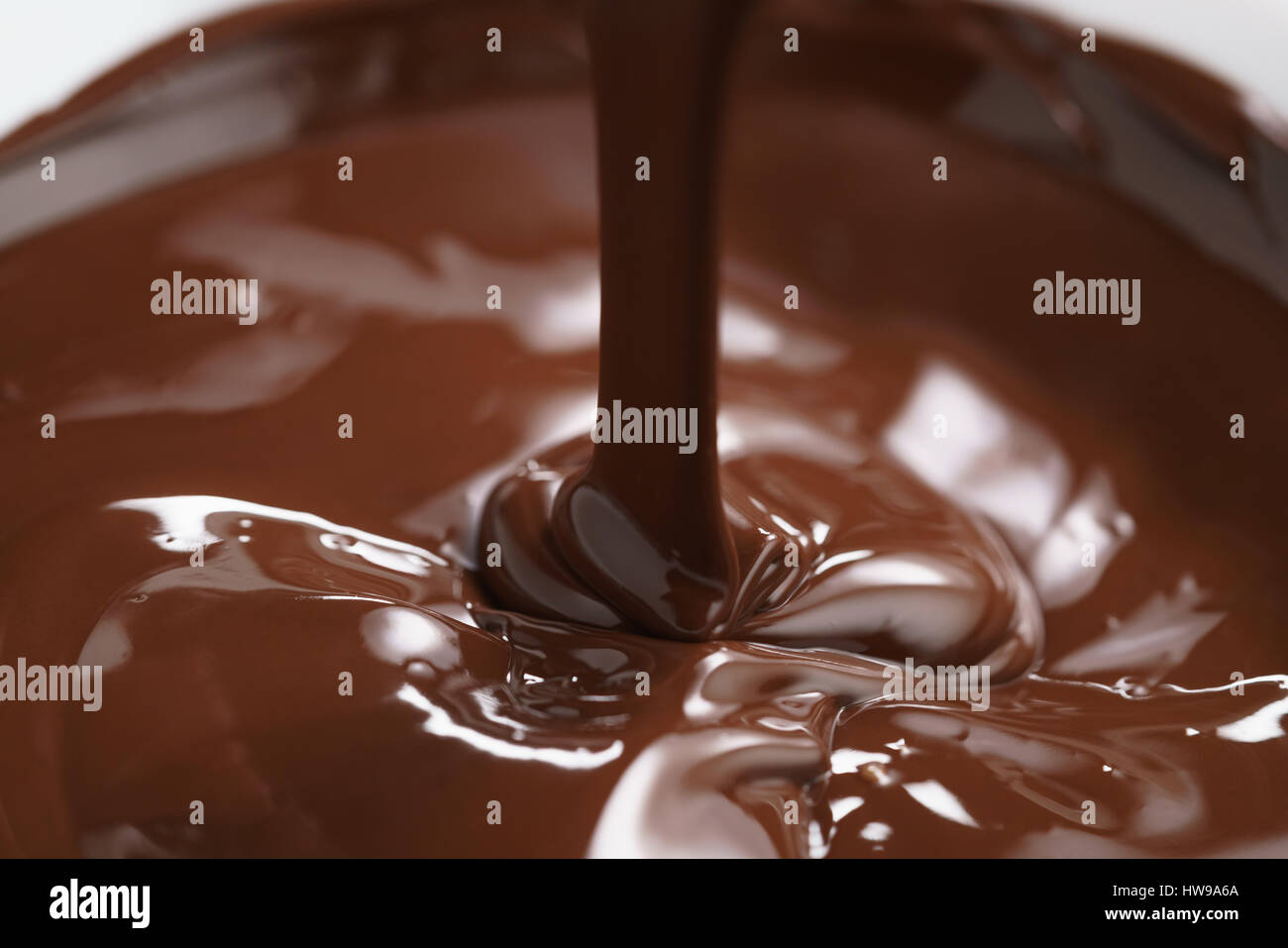 macro photo of premium dark chocolate pour in bowl Stock Photo - Alamy