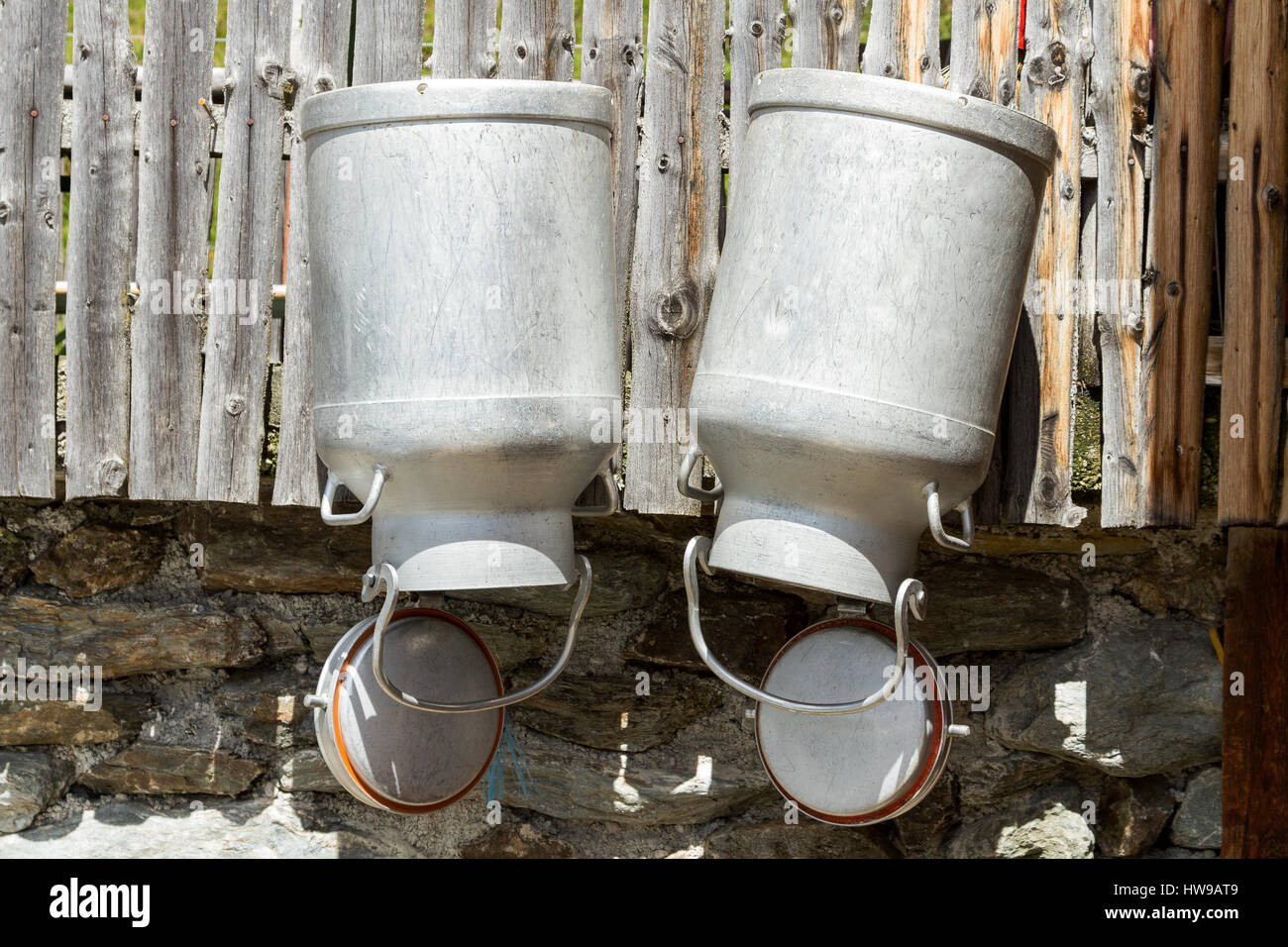 Milk cans hanging on a wood fence. Country scene, Austria, Tyrol Stock ...