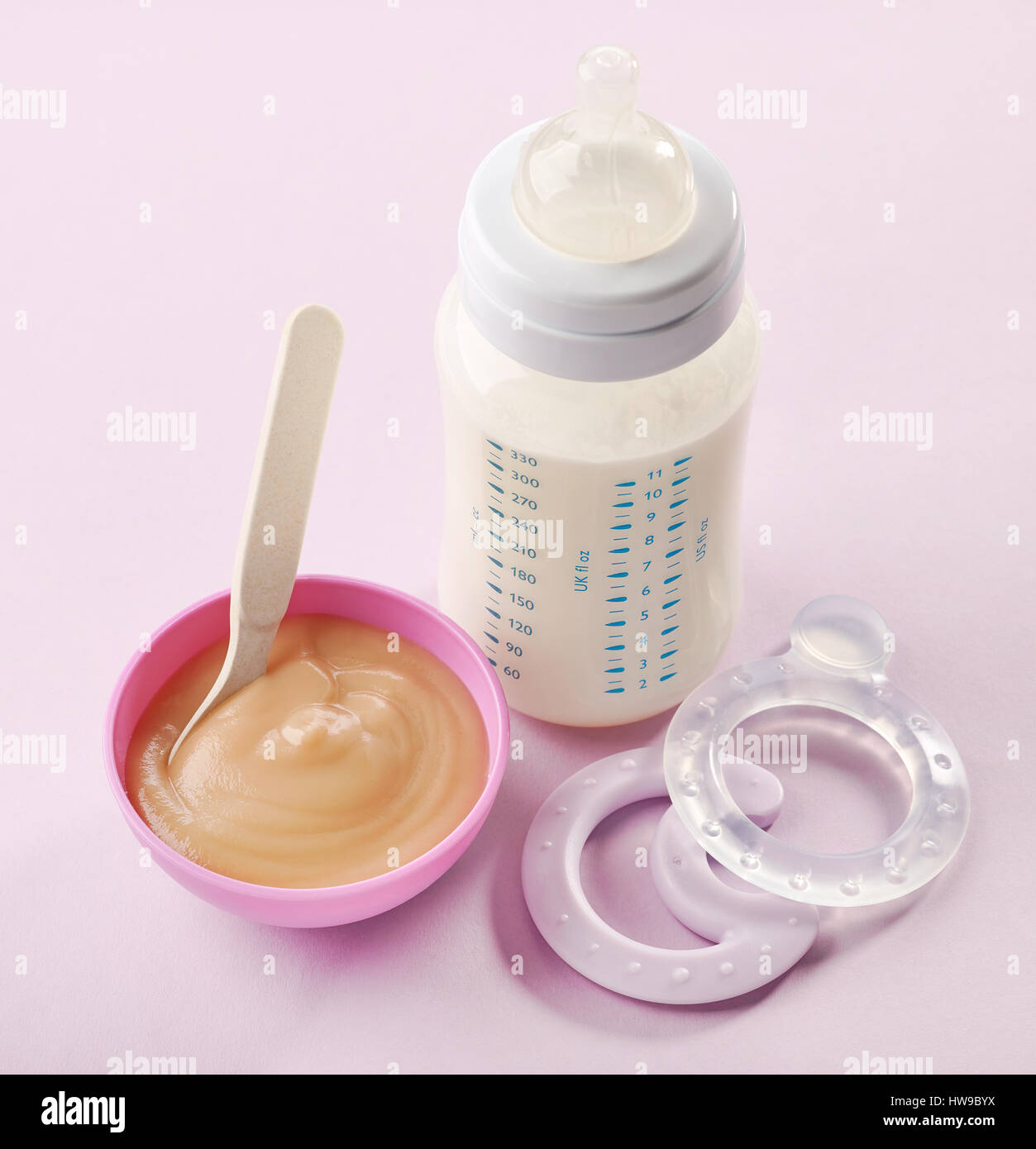 baby milk bottle and pureed apple on purple background Stock Photo - Alamy