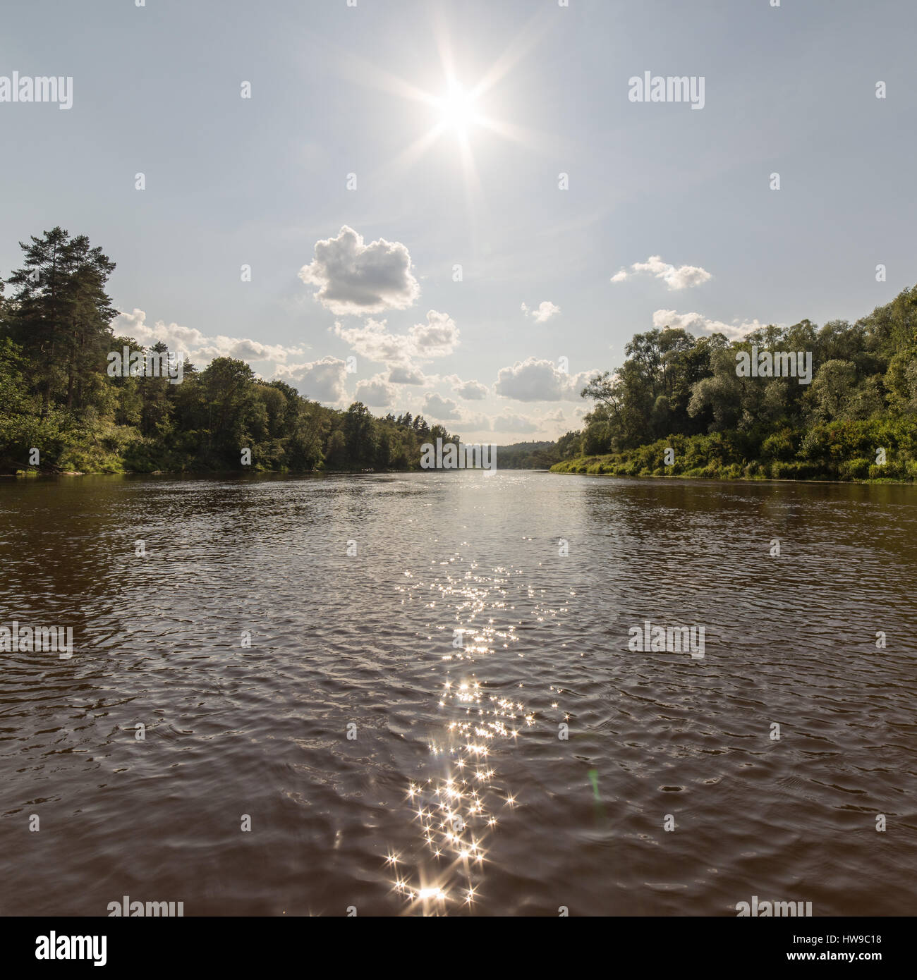 Picturesque river view with clouds and trees in the background Stock ...