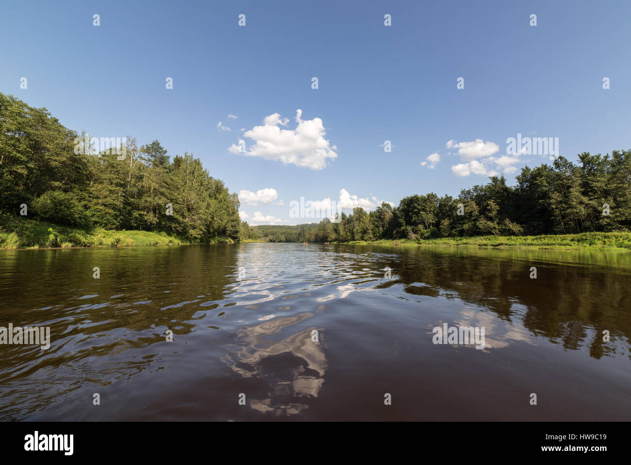 Picturesque river view with clouds and trees in the background Stock ...