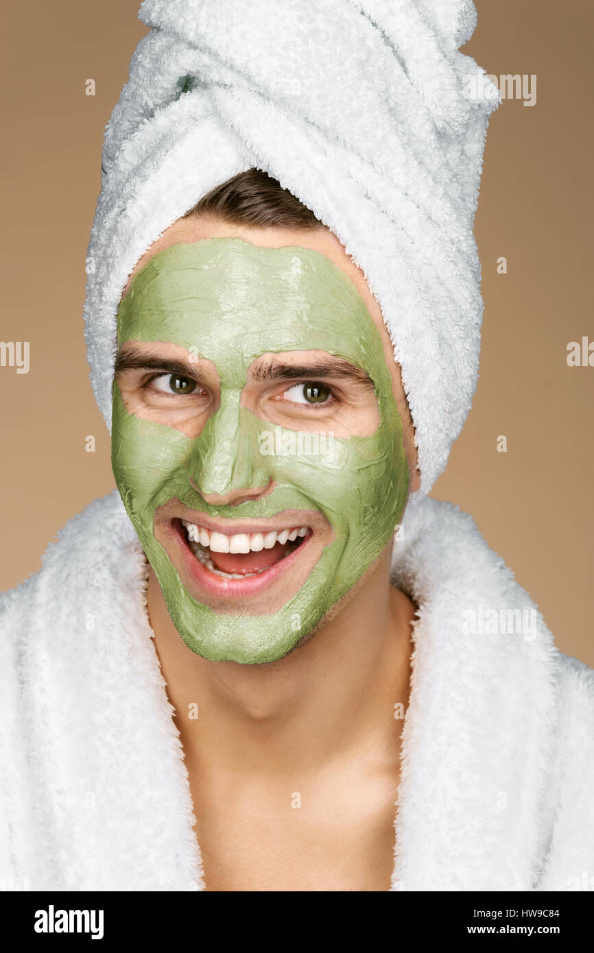 Laughing man with facial mask of avocado. Photo of Happy man smiling ...
