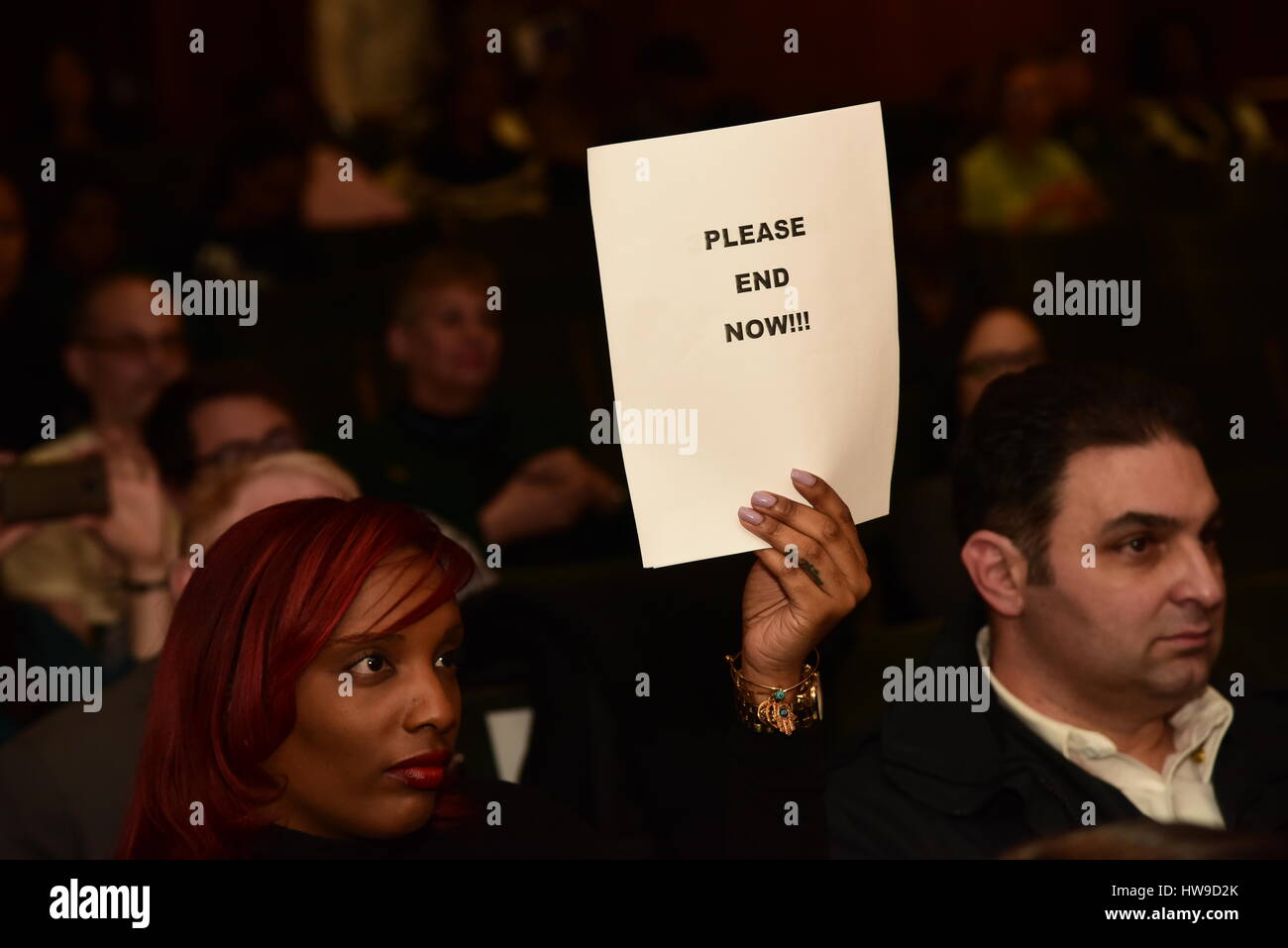 New York City, United States. 17th Mar, 2017. Holding up a card to ...