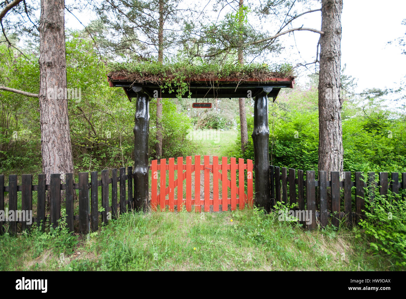 red gates on the black fence Stock Photo - Alamy