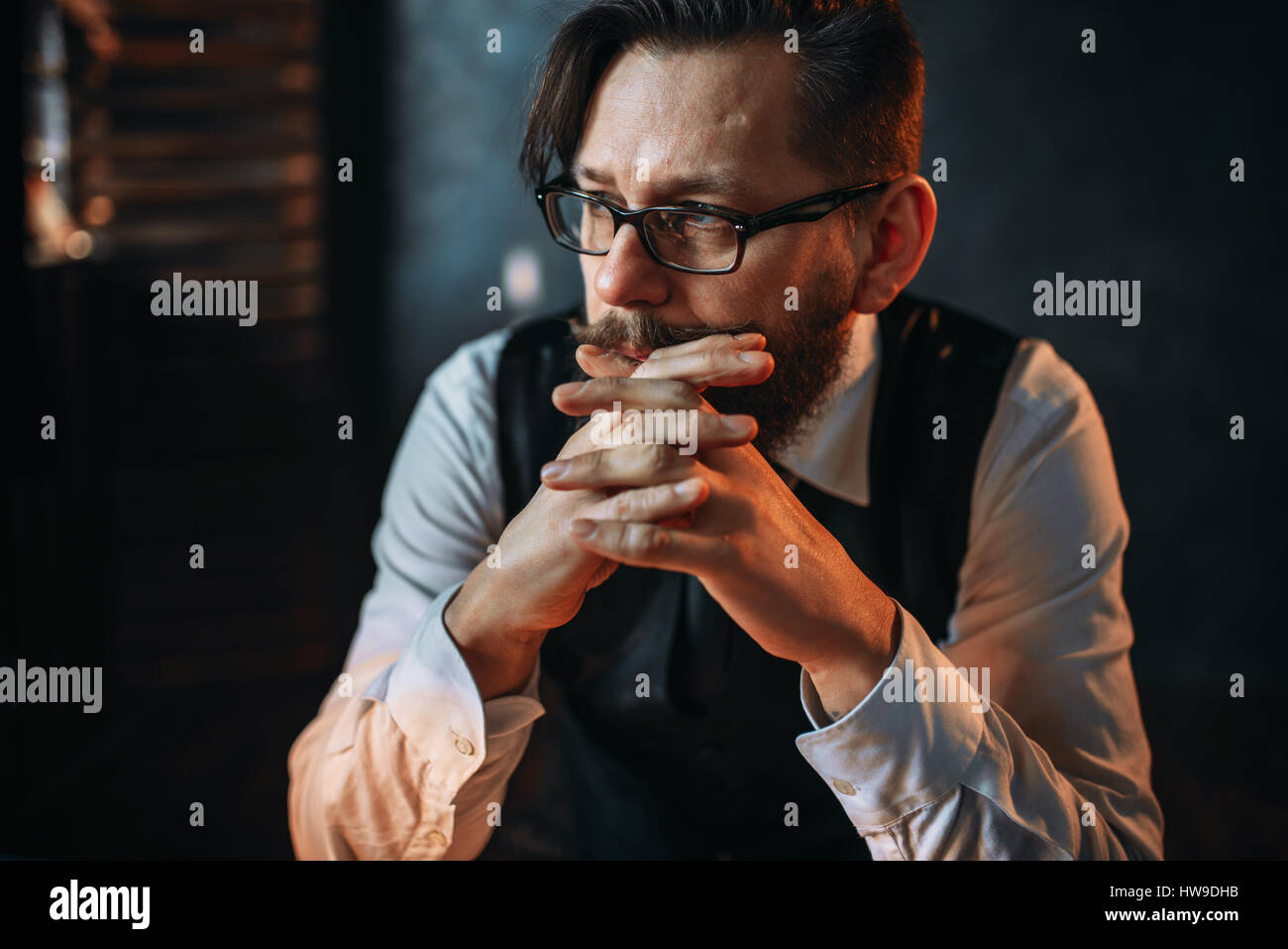 Portrait of serious brooding, bearded man in glasses. Writer ...