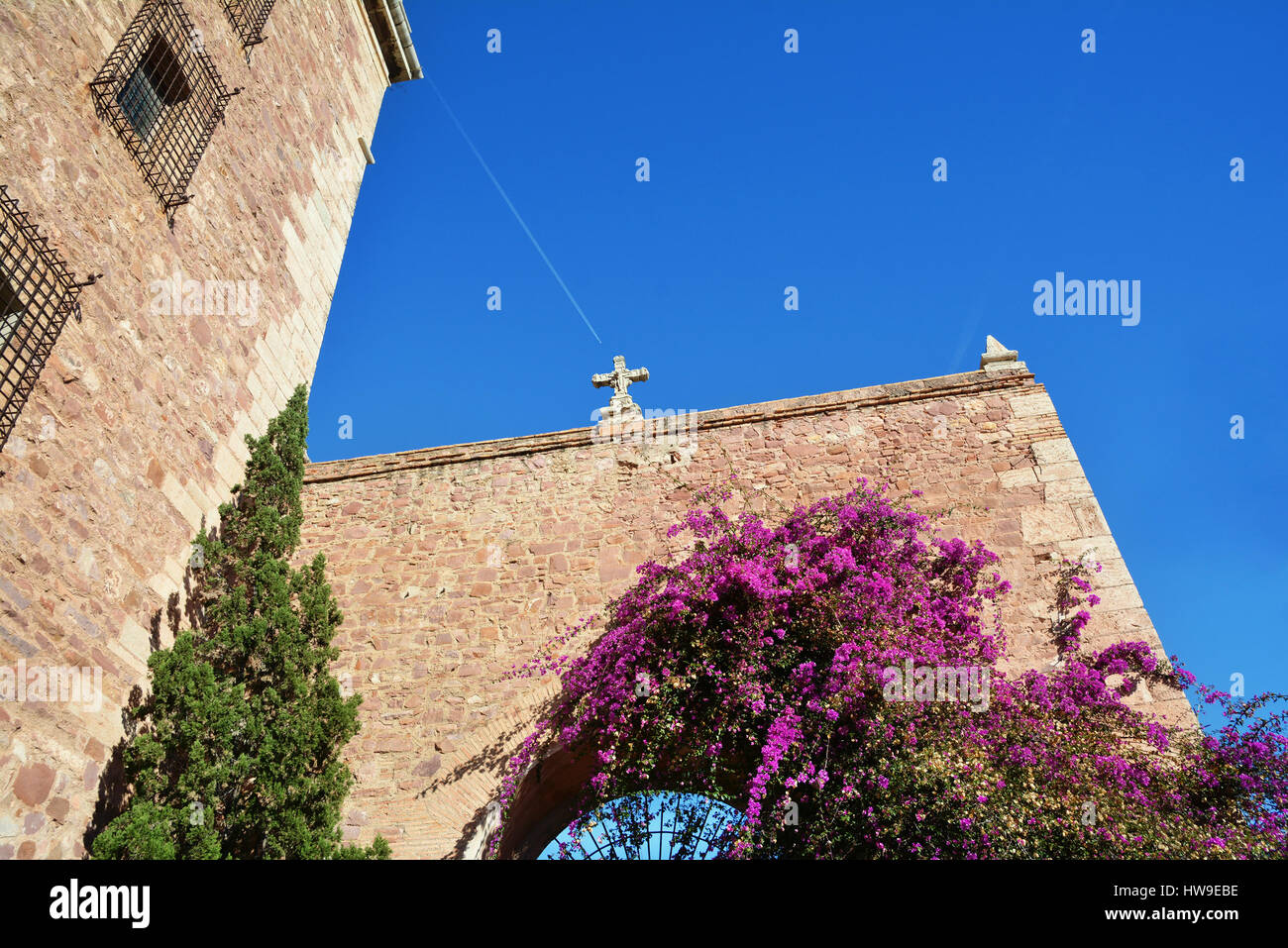 Colorful detail with beautiful pink flowers and ancient gate in El Puig ...