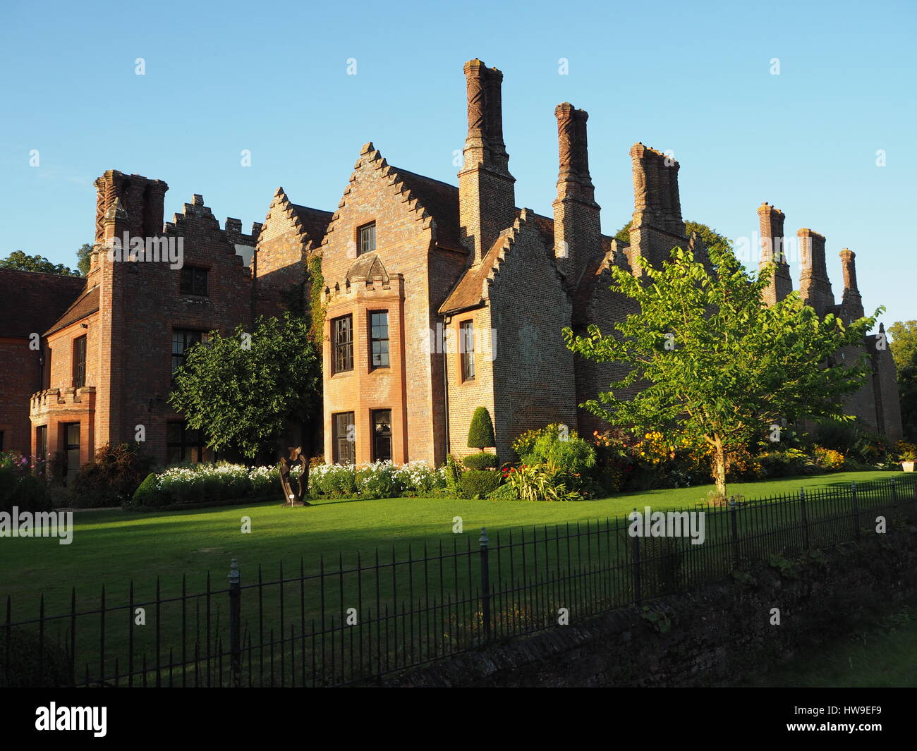 Chenies Manor House showing the Tudor chimneys against a bright blue ...