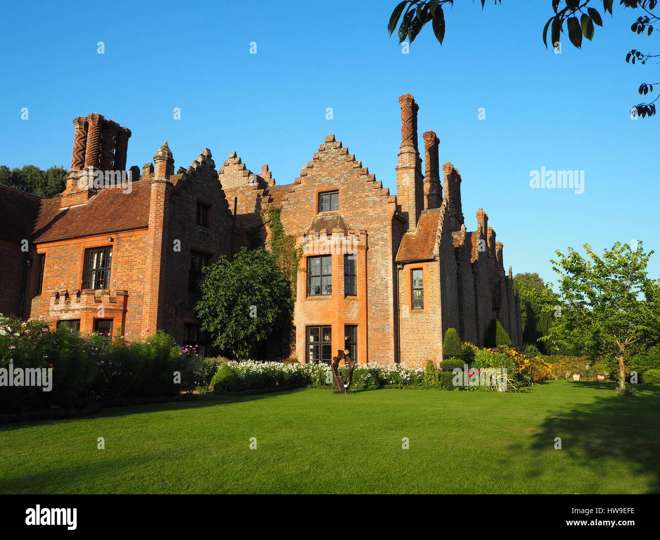 Chenies Manor House showing the Tudor chimneys against a bright blue ...