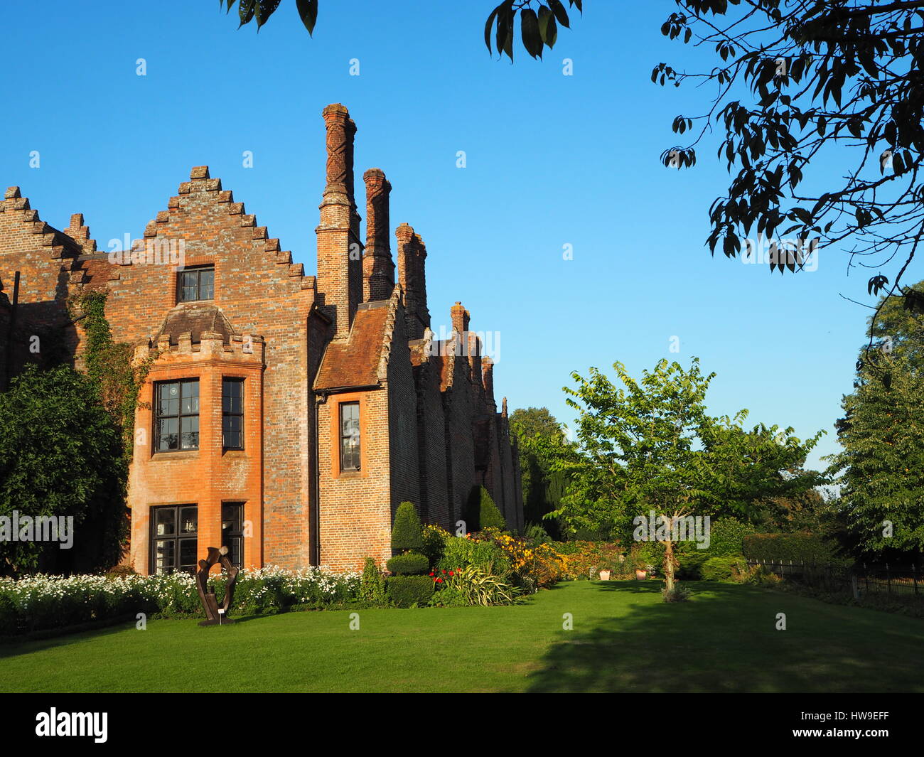 Chenies Manor House showing the Tudor chimneys against a bright blue ...