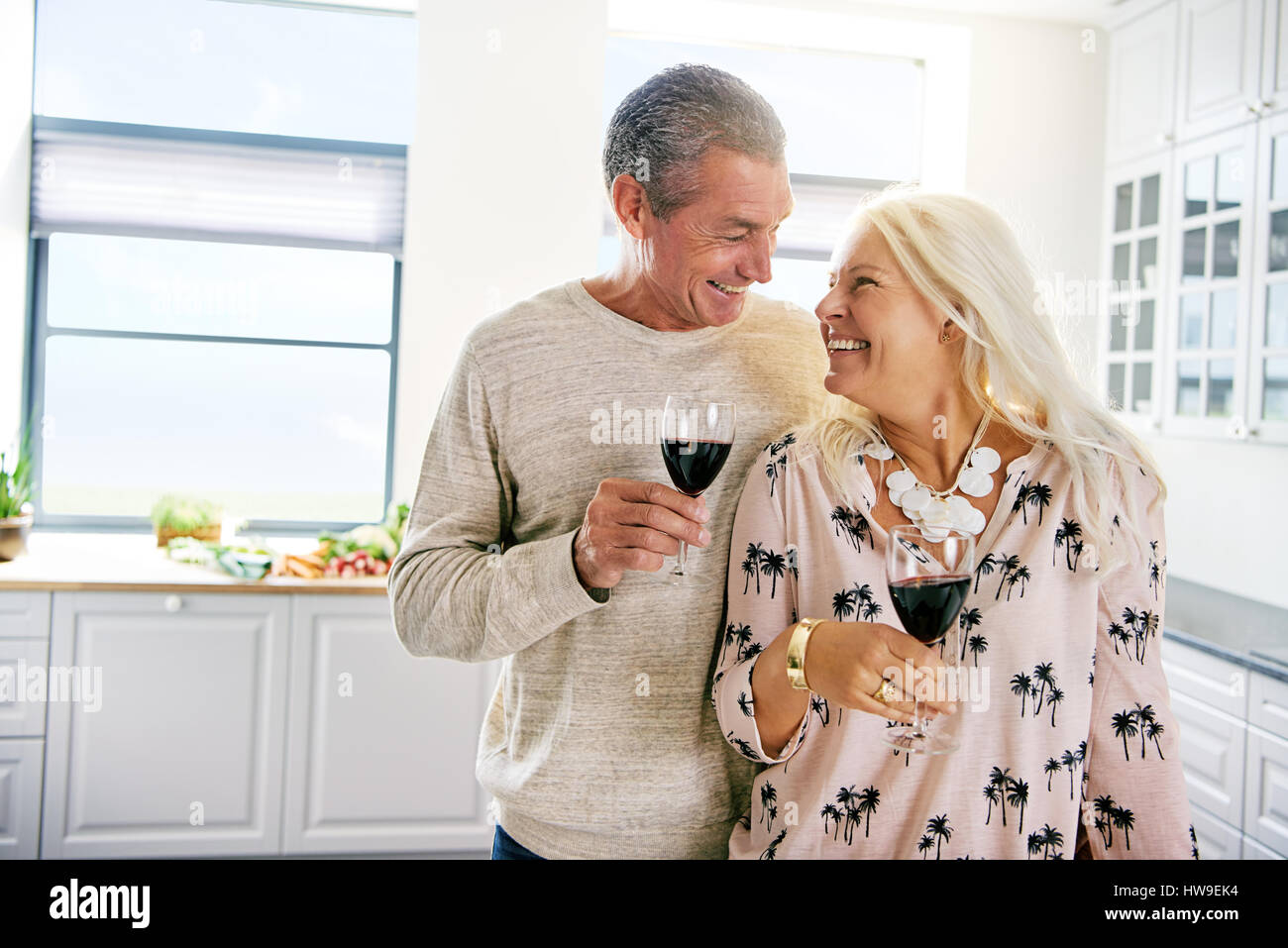 Smiling happy elderly couple enjoying retirement relaxing together in ...