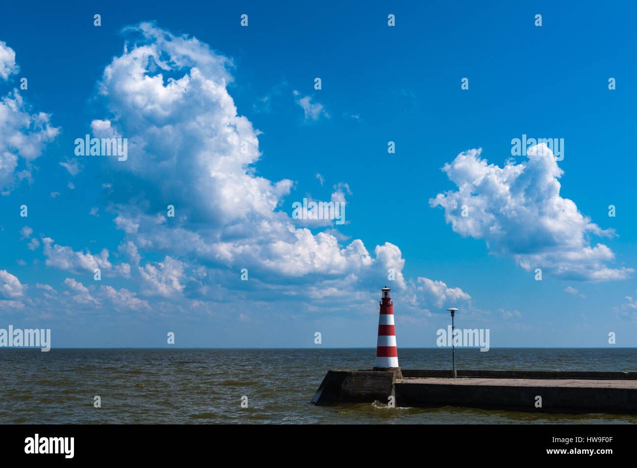 Great summer sunshine at the habor entrance with the lighthouse, Nida ...