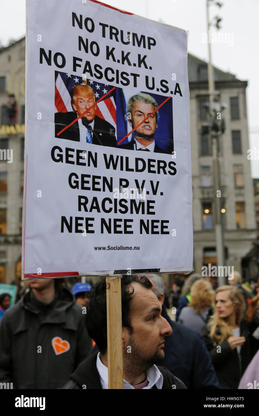 Amsterdam, Netherlands. 18th Mar, 2017. An activist holds a sign that ...