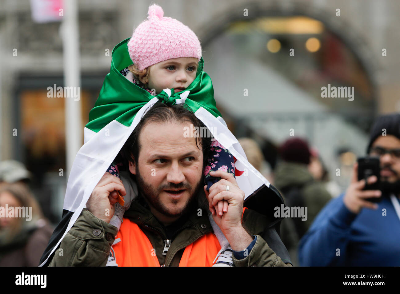 Amsterdam, Netherlands. 18th Mar, 2017. A Syrians father carries his ...