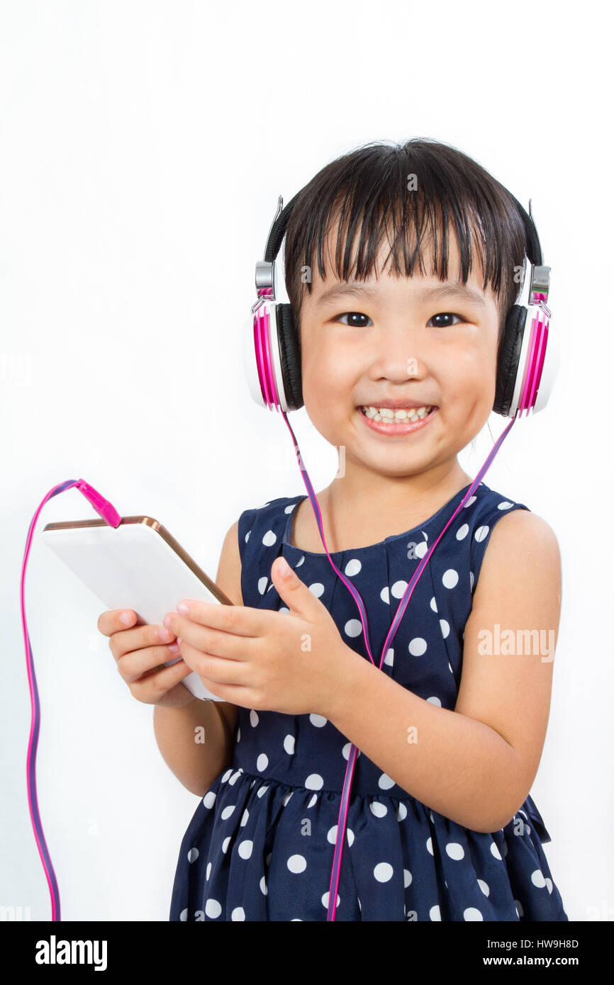 Asian Little Chinese Girl Using Mobile Phone with Headset isolated on ...