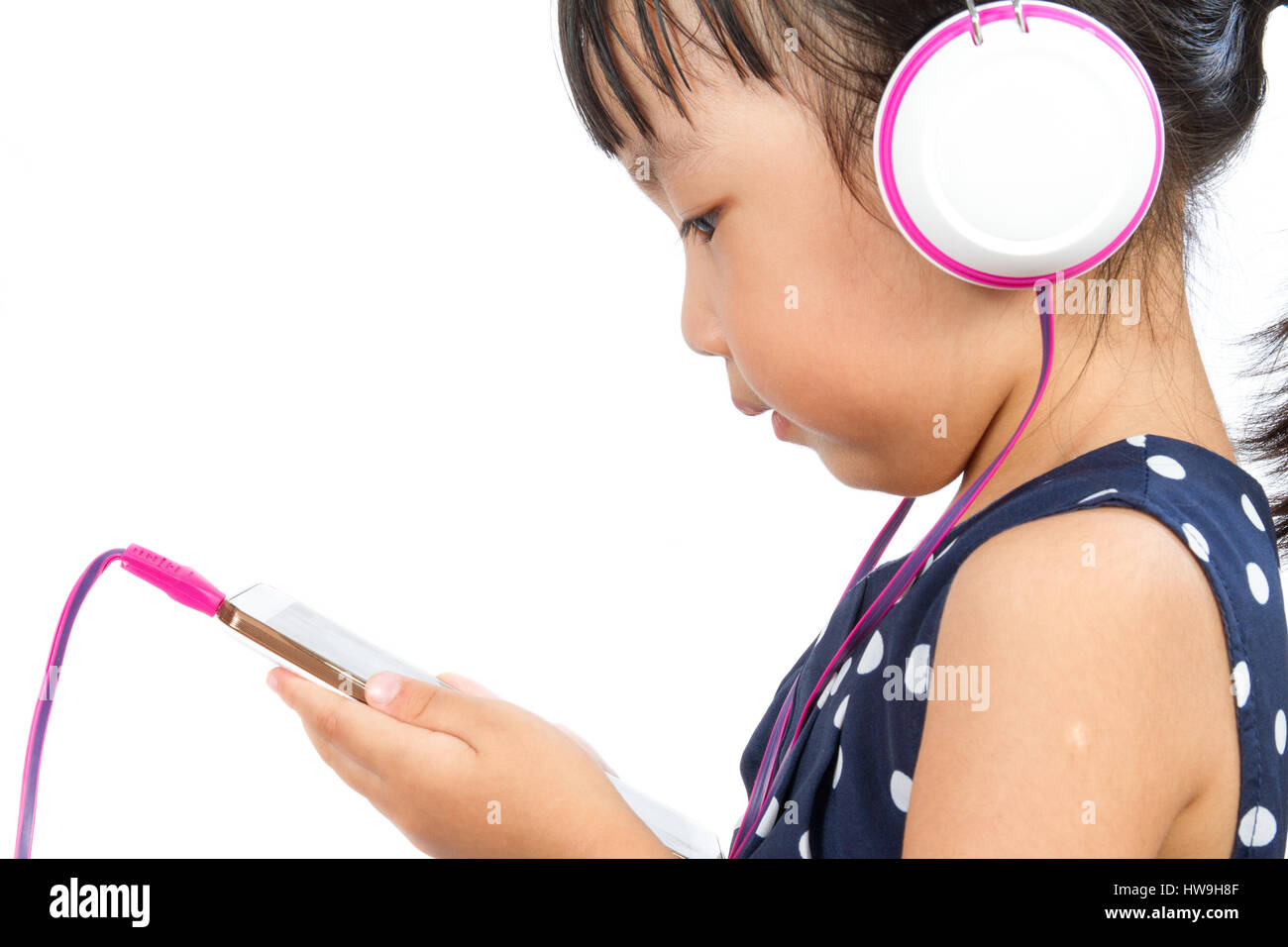 Asian Little Chinese Girl Using Mobile Phone with Headset isolated on ...