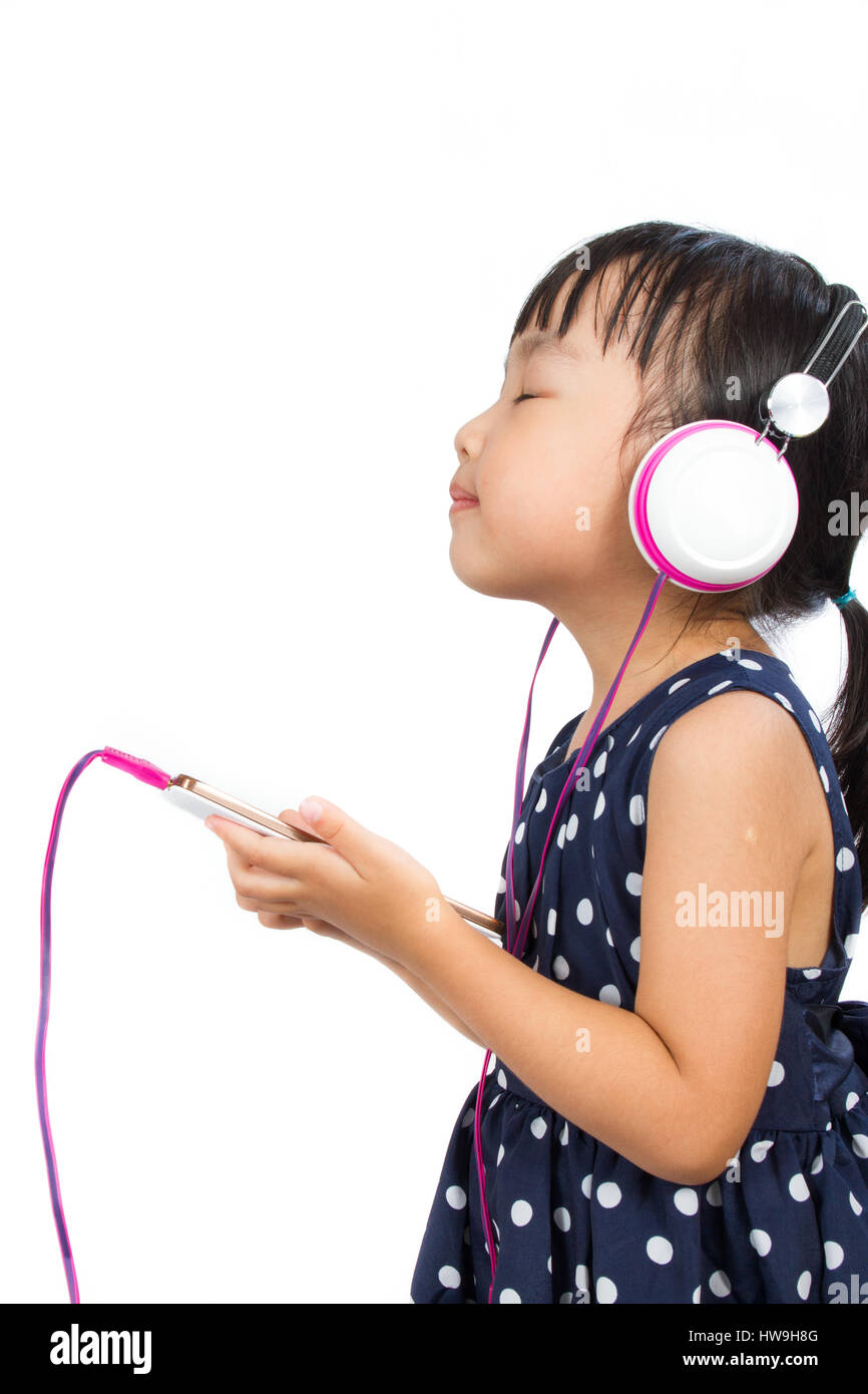 Asian Little Chinese Girl Using Mobile Phone with Headset isolated on ...