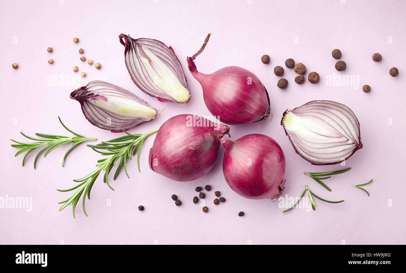 composition of red onions and spices on purple background, top view ...