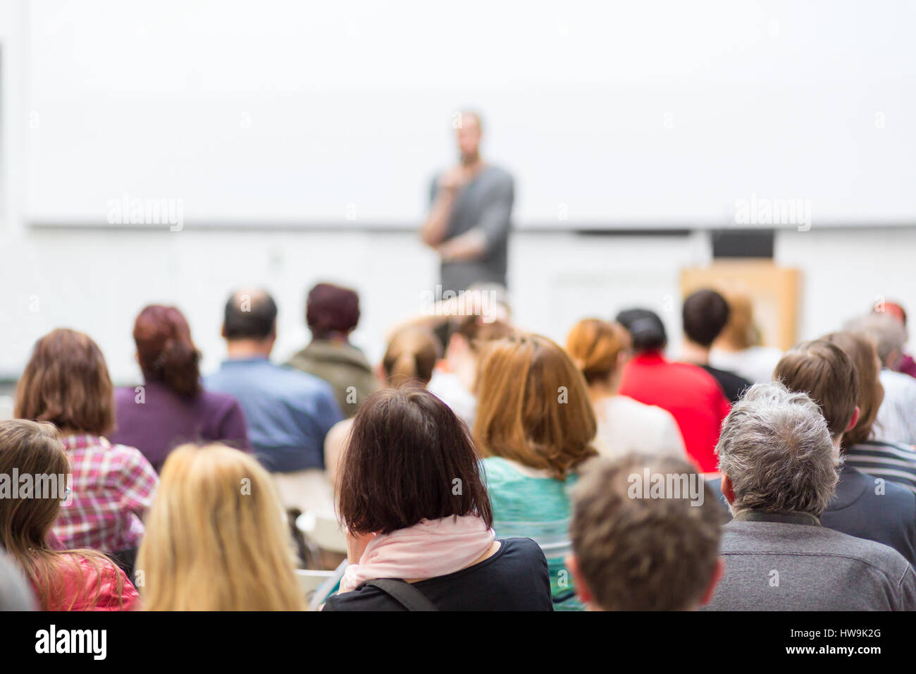 Man giving presentation in lecture hall at university Stock Photo - Alamy
