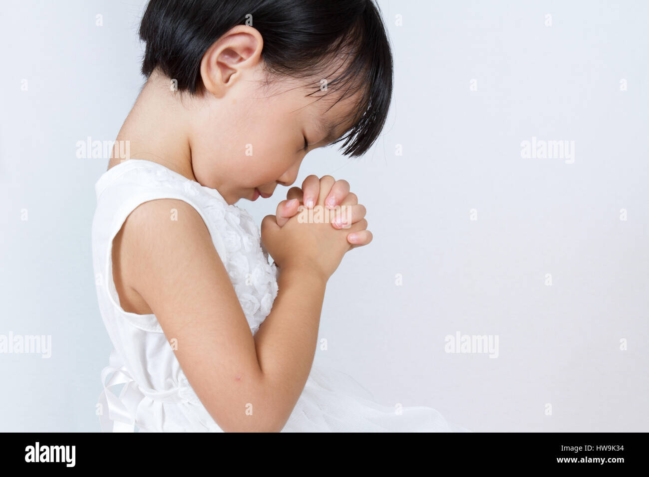Asian Little Chinese Girl Praying in isolated White Background Stock ...