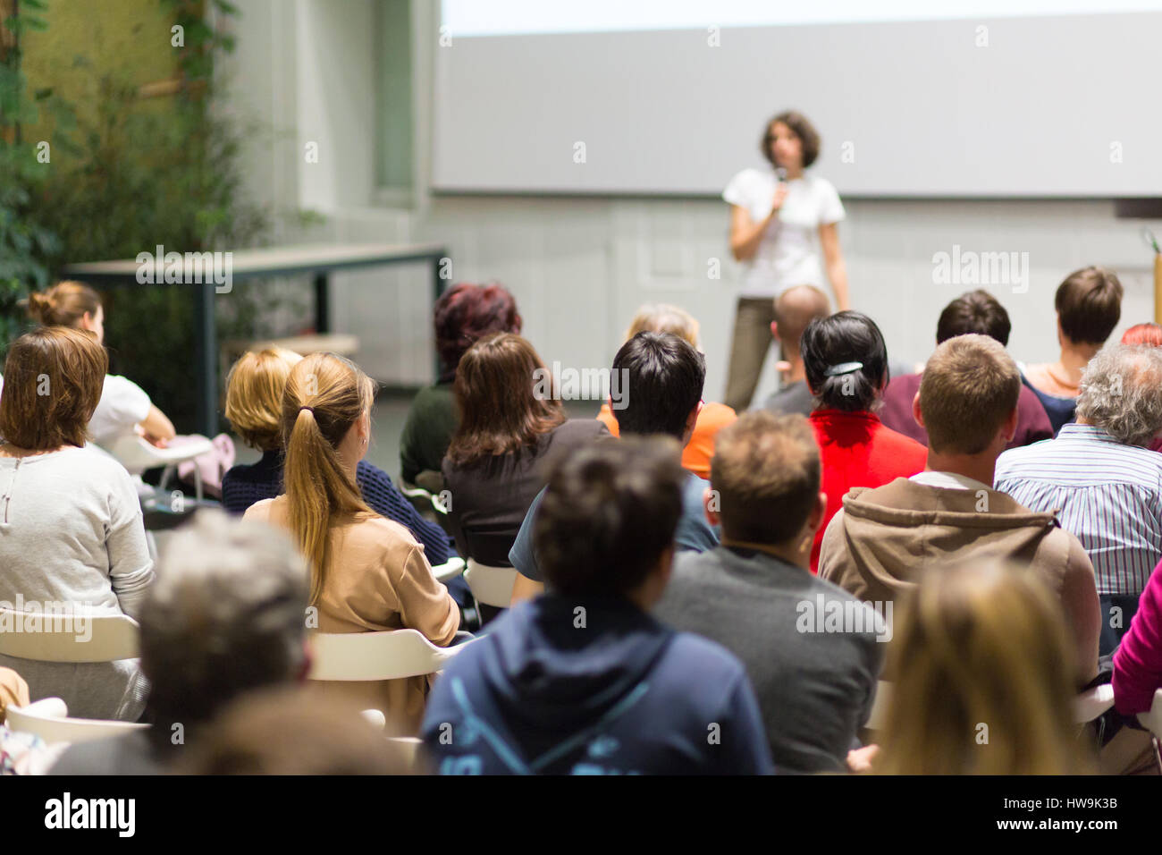 Woman giving presentation in lecture hall at university Stock Photo - Alamy