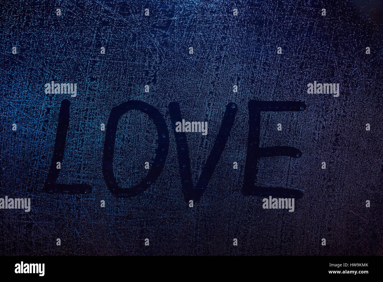 Love word concept draw on frozen window texture. Love word on wet glass ...