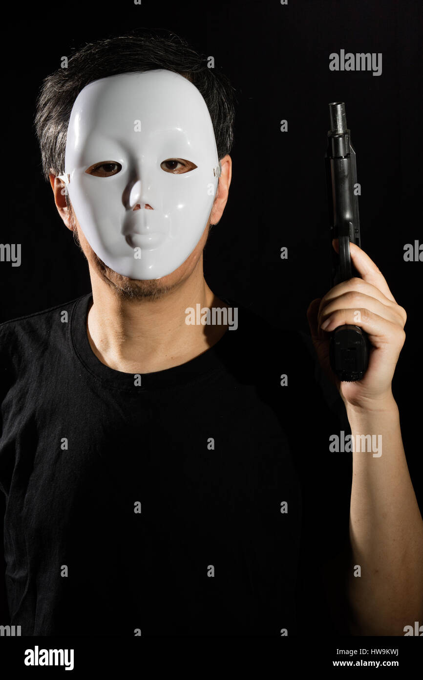Man in disguise holding gun hi-res stock photography and images - Alamy