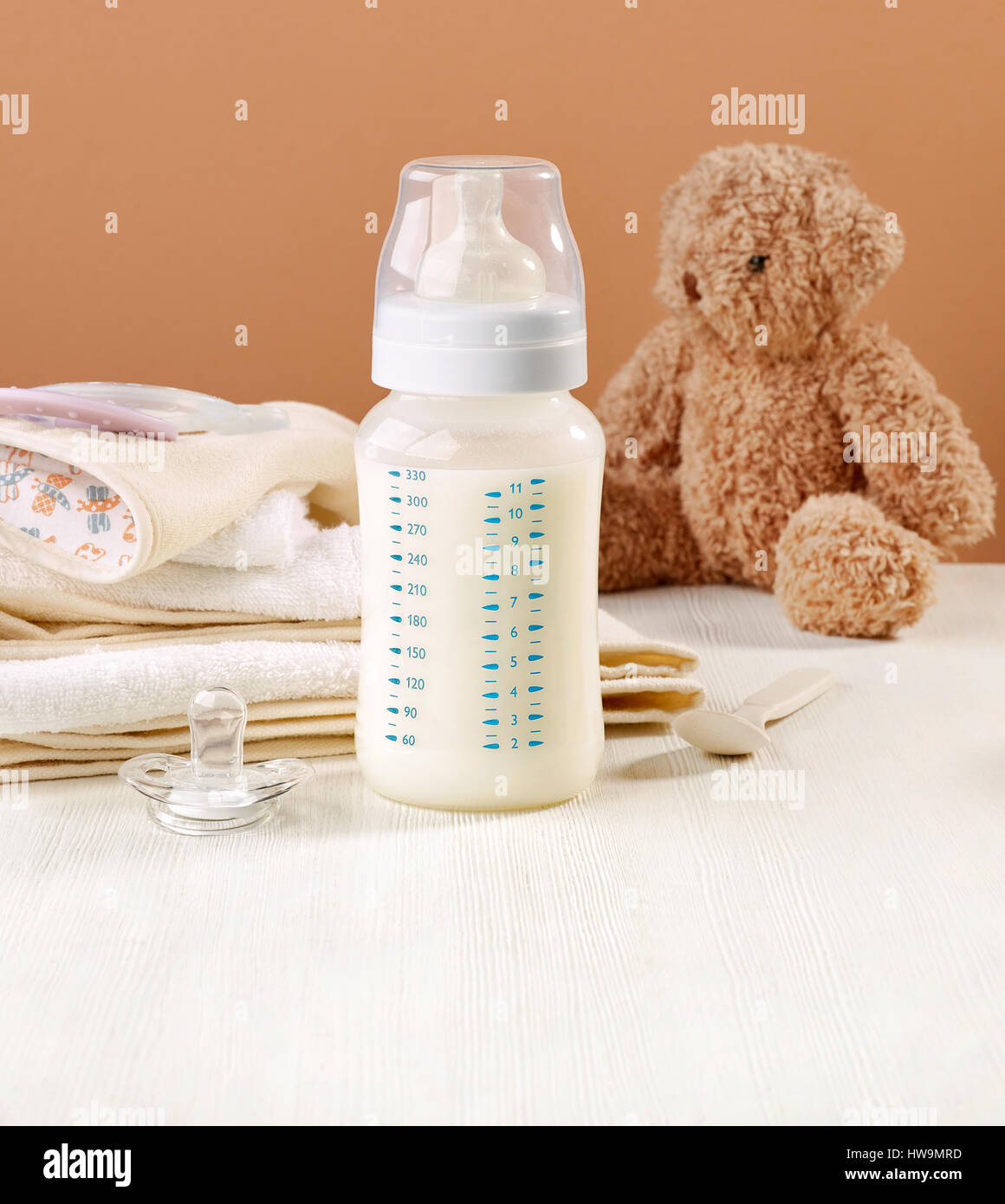 baby milk bottle on white wooden table Stock Photo - Alamy