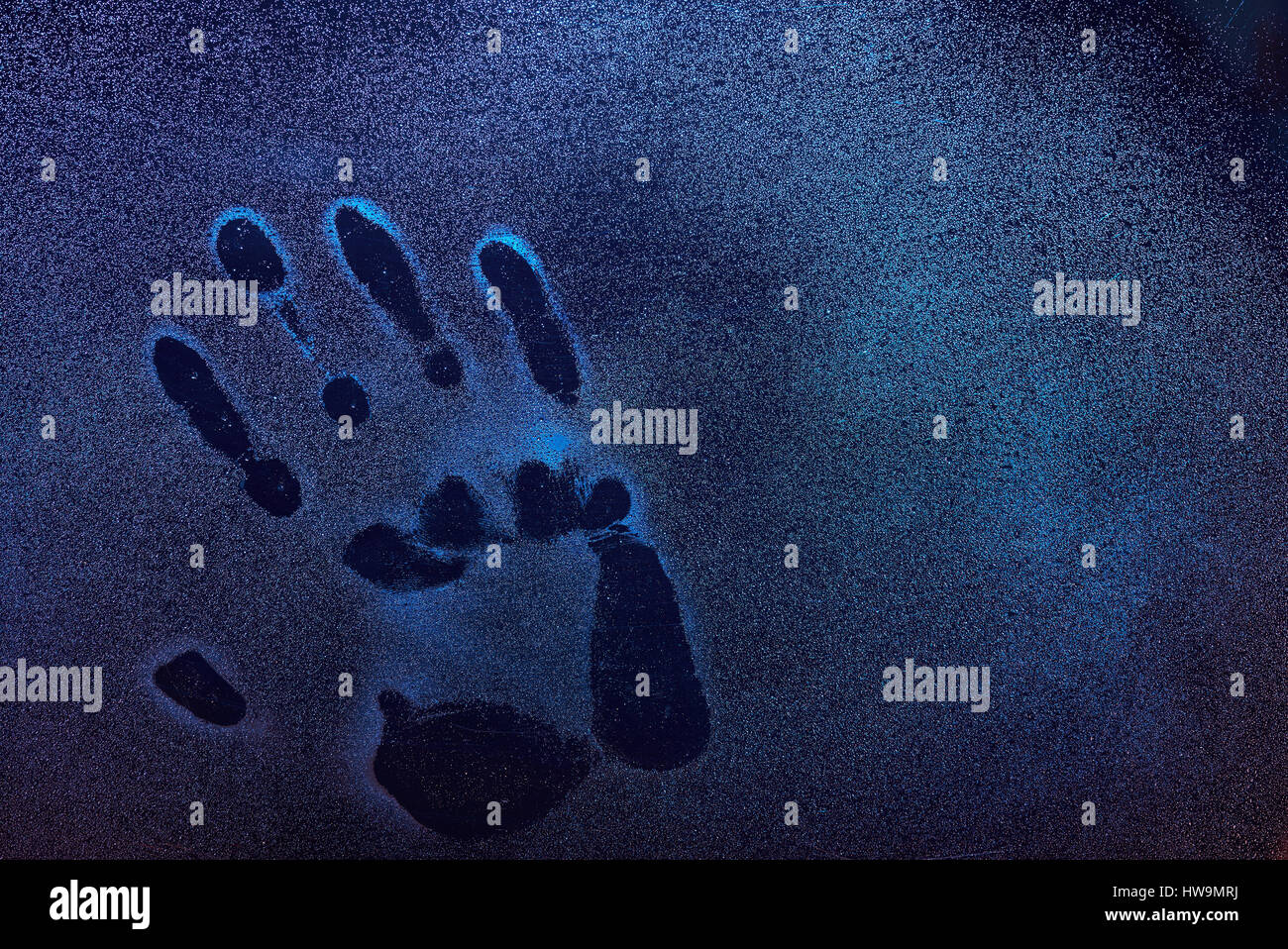 Human palm trace on frozen window background. Man hand shape sign on ...