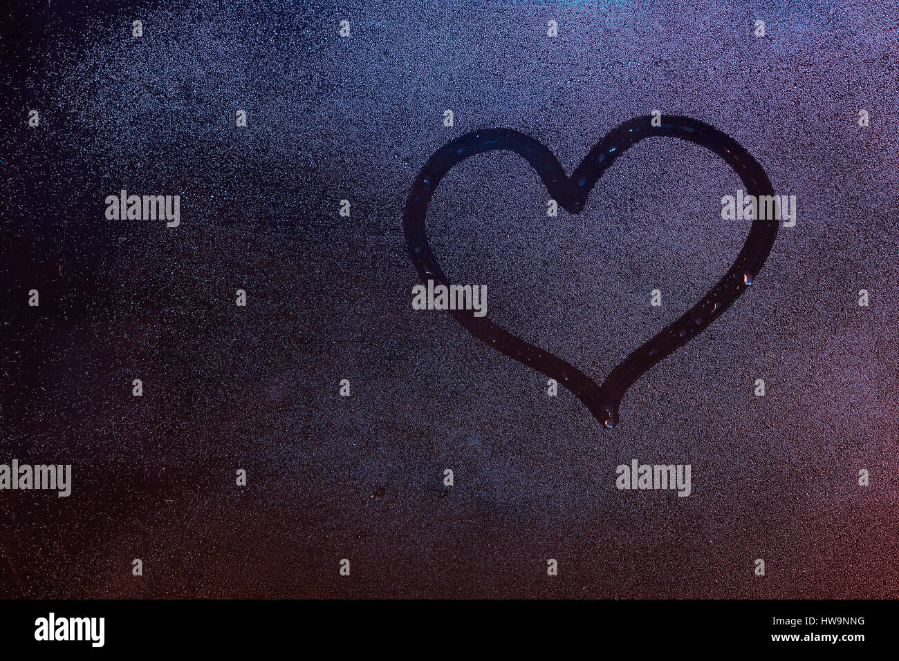 Heart shape drawing on fog window background. Heart symbol on wet ...