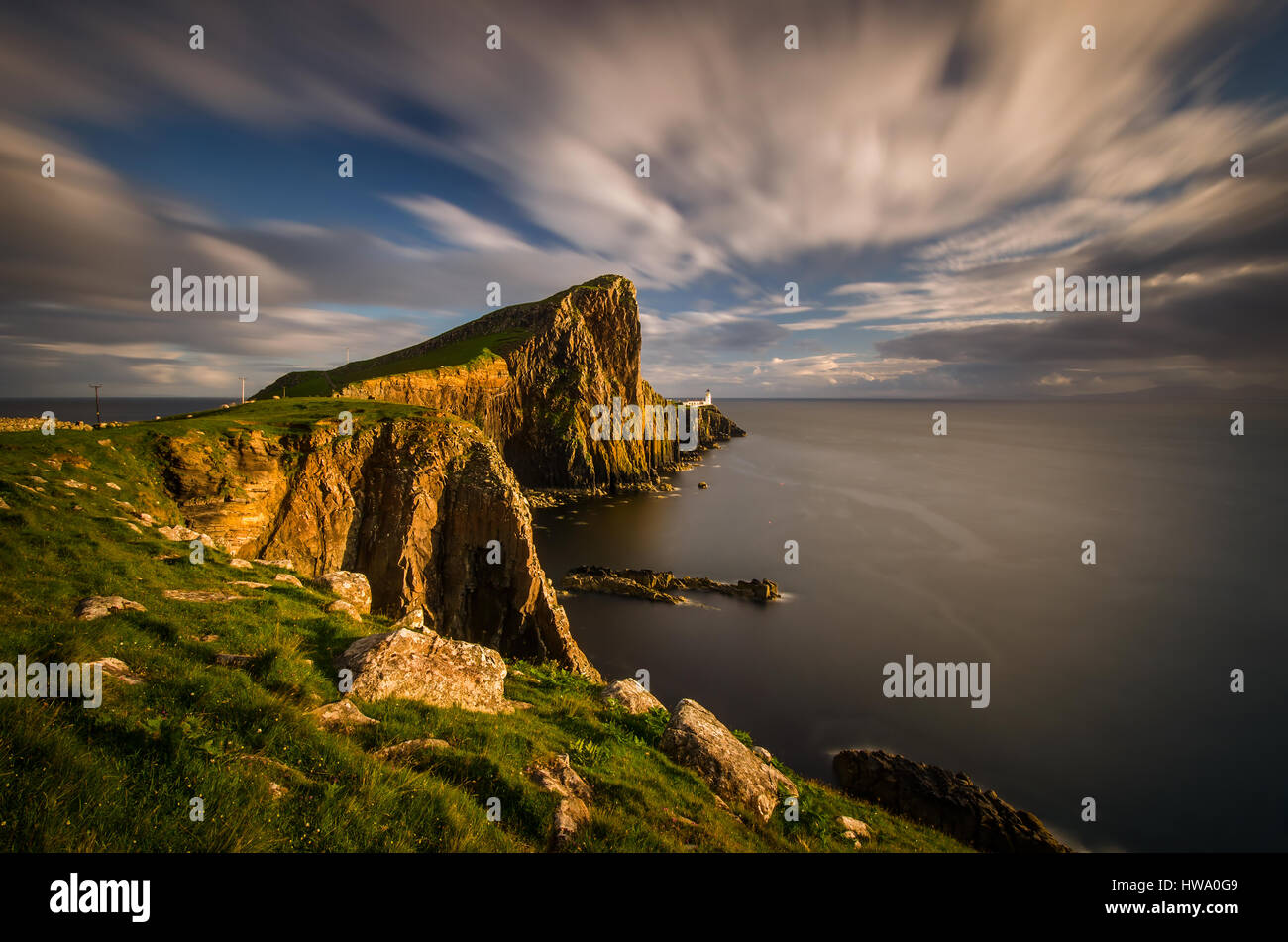 Neist Point cliffs and lighthouse in sunset light, Isle of Skye ...