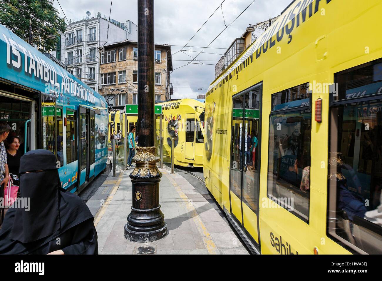Turkey, Istanbul, woman in niqab passing between two trams Stock Photo ...