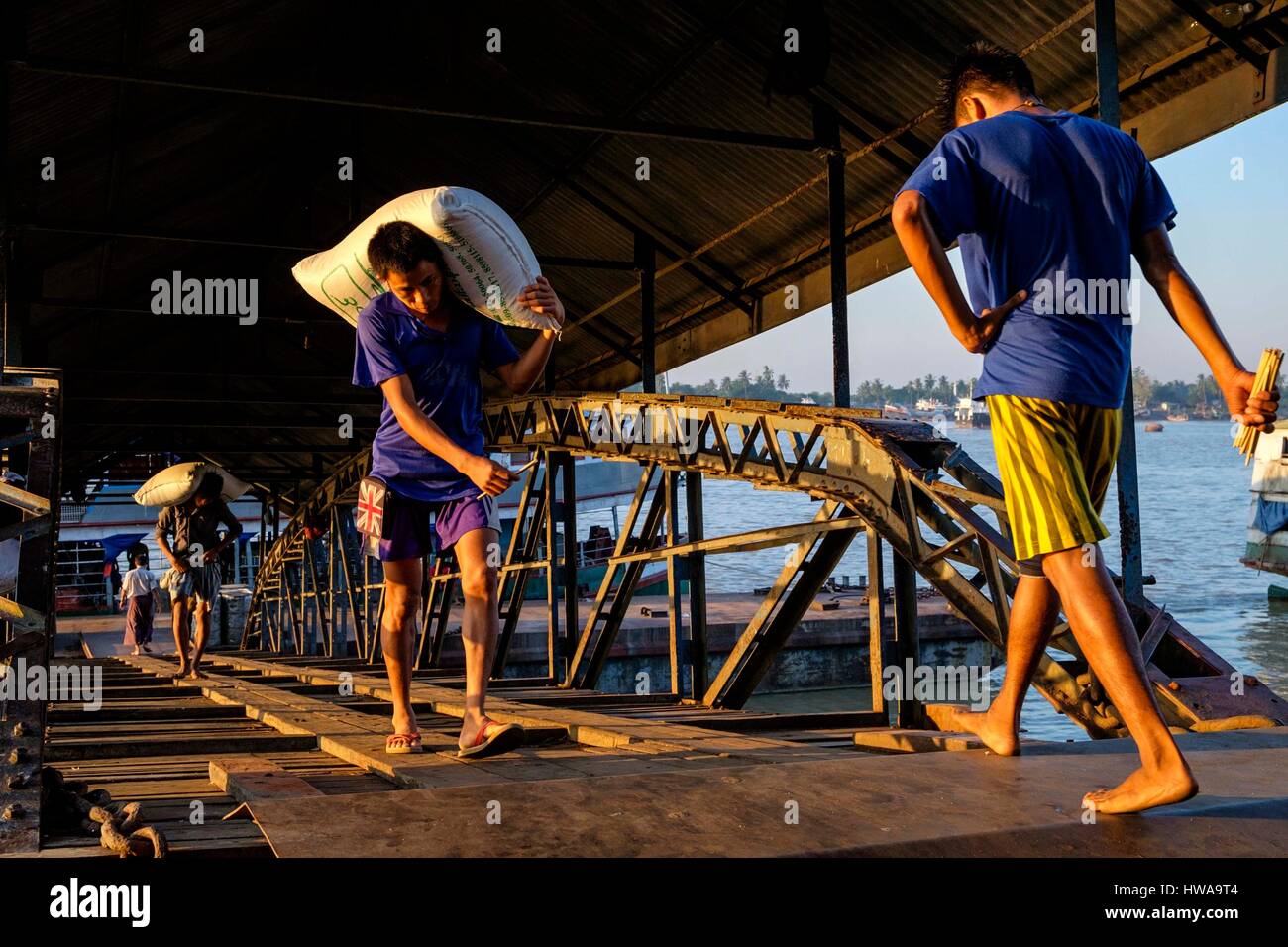 Myanmar, Yangon, old city, Unloading boats along Yangon river Stock ...