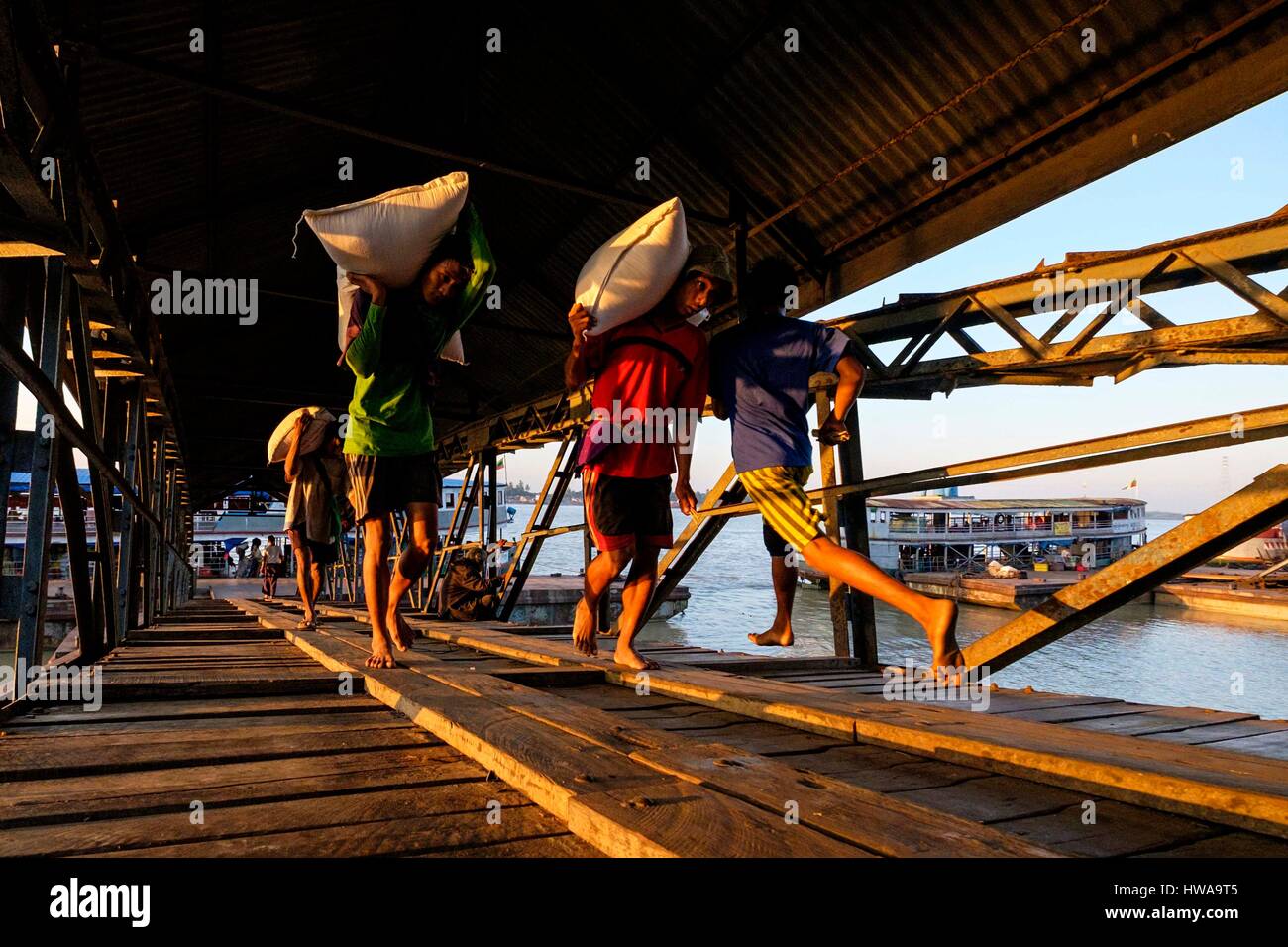 Myanmar, Yangon, old city, Unloading boats along Yangon river Stock ...